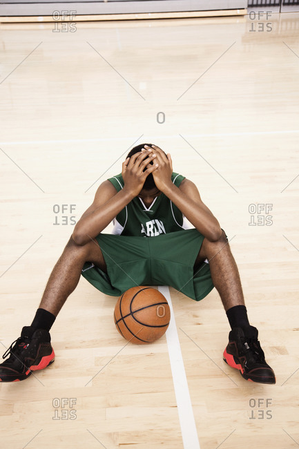 African basketball player with head in hands - Stock Image - Everypixel