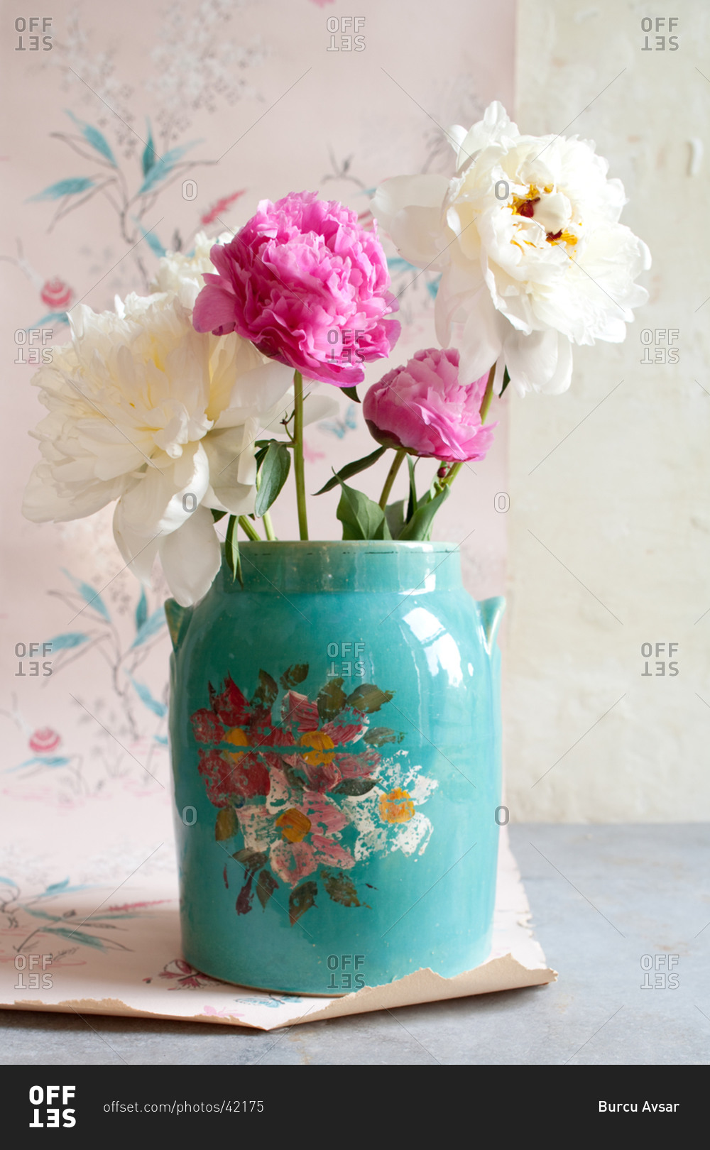 Flowers in a large teal vase stock photo - OFFSET