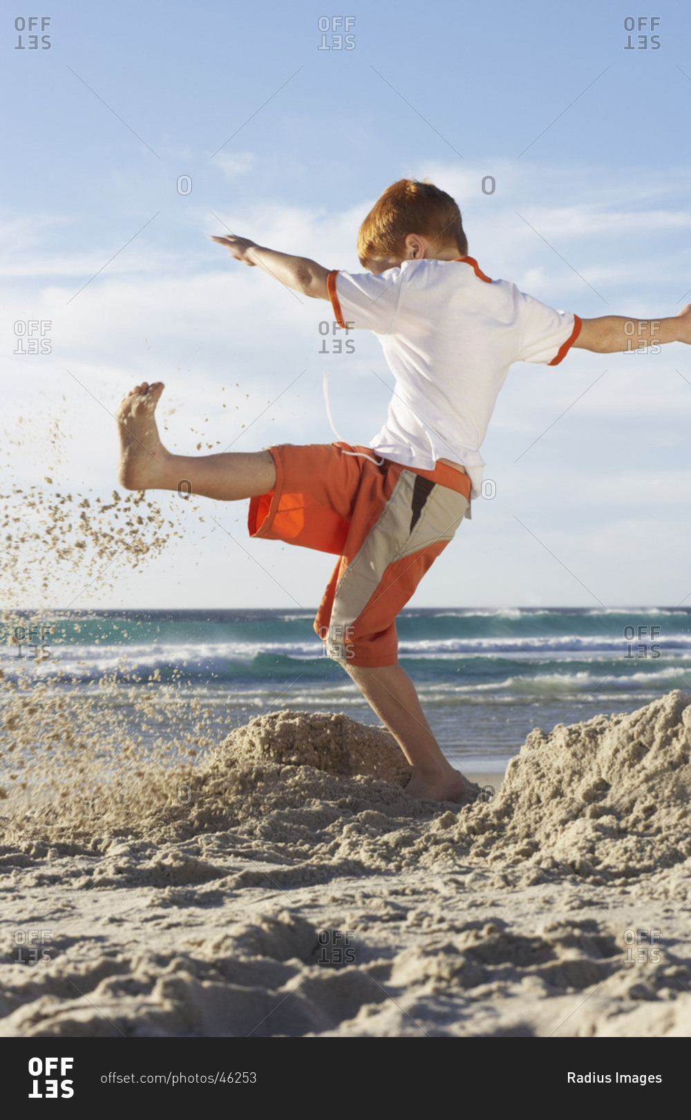 Boy kicking sandcastles - Offset Collection stock photo - OFFSET