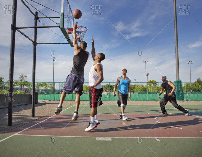 Streetball basketball game with young players on public court stock ...