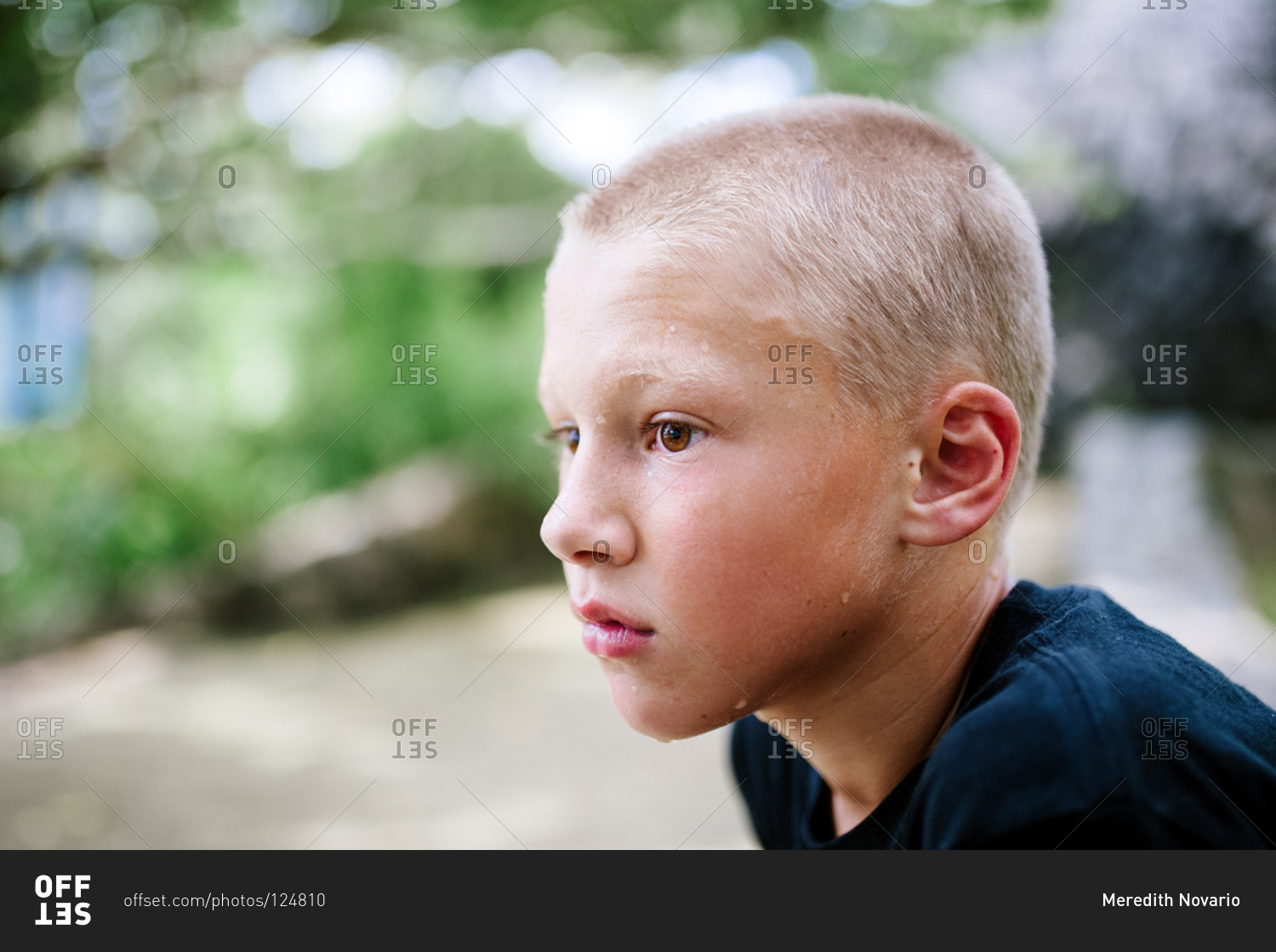 Profile of a sweating boy stock photo - OFFSET