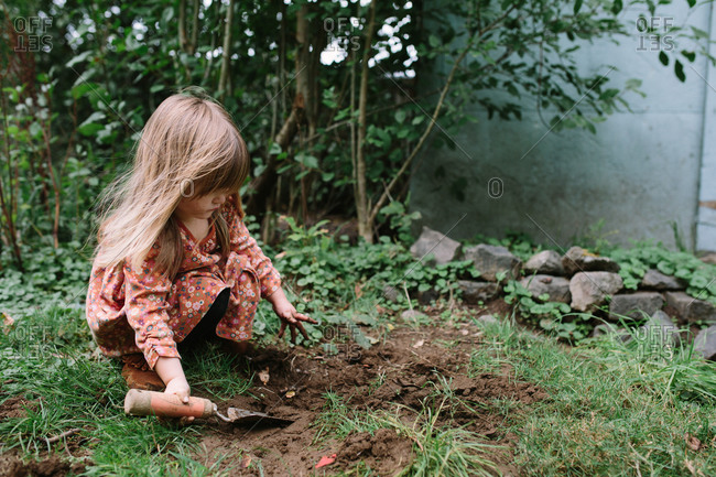 Girl With A Shovel Digging A Ditch