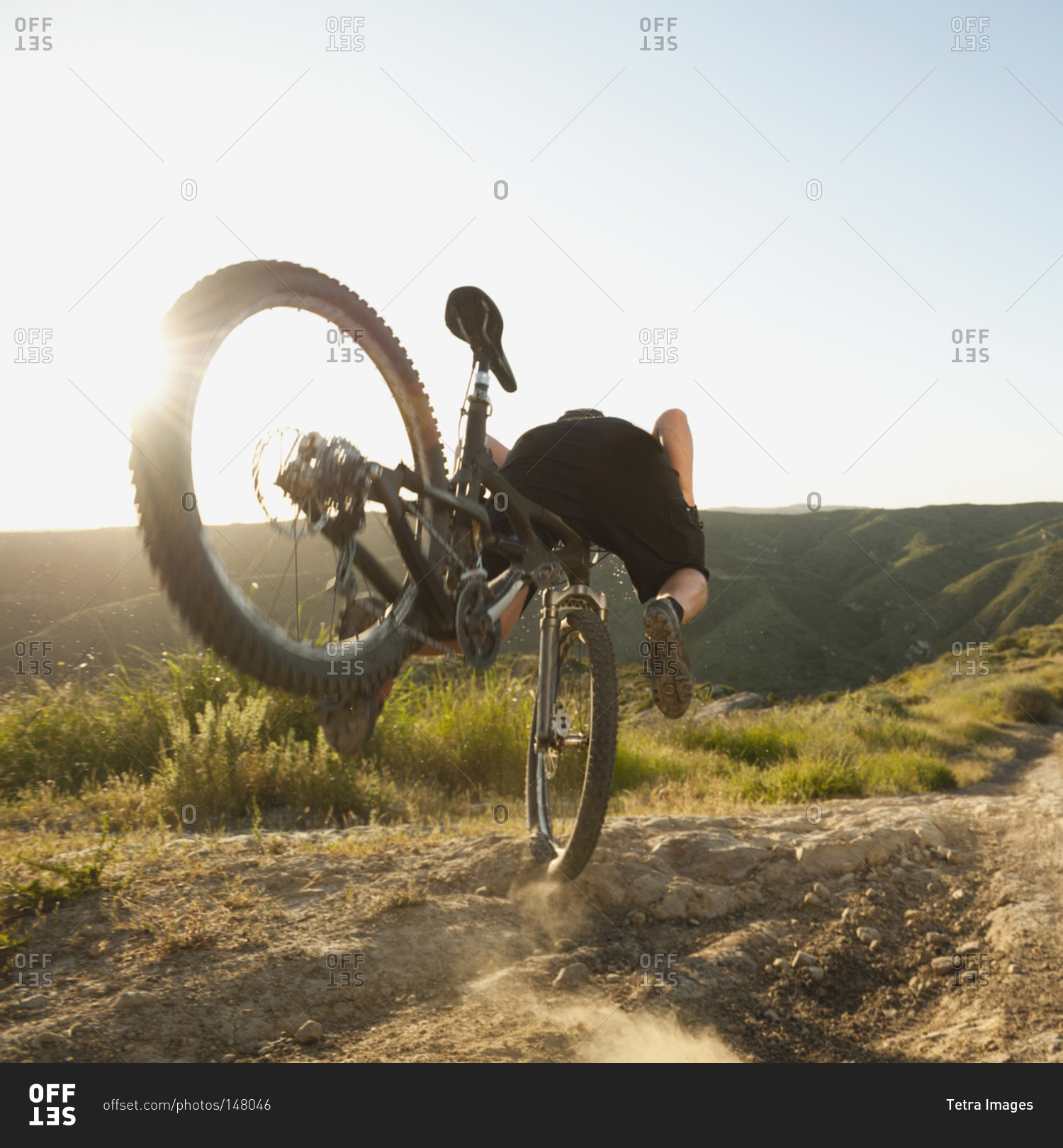 Mountain biker falling of his bike stock photo - OFFSET