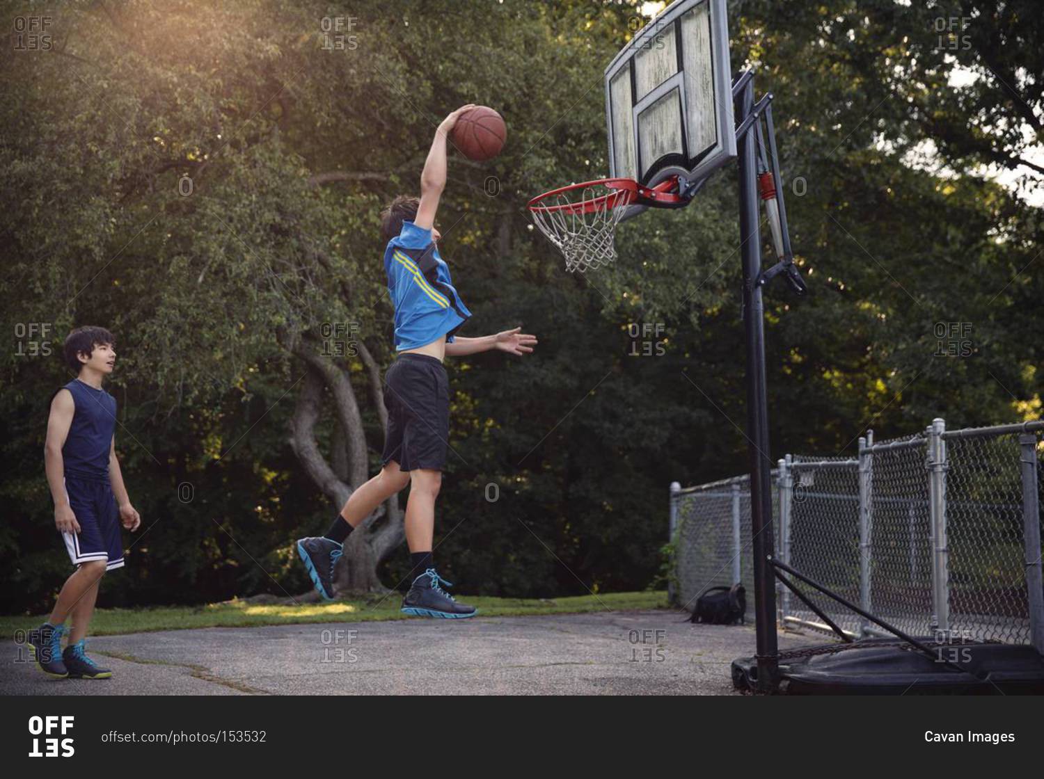 Boys Playing Basketball Outside