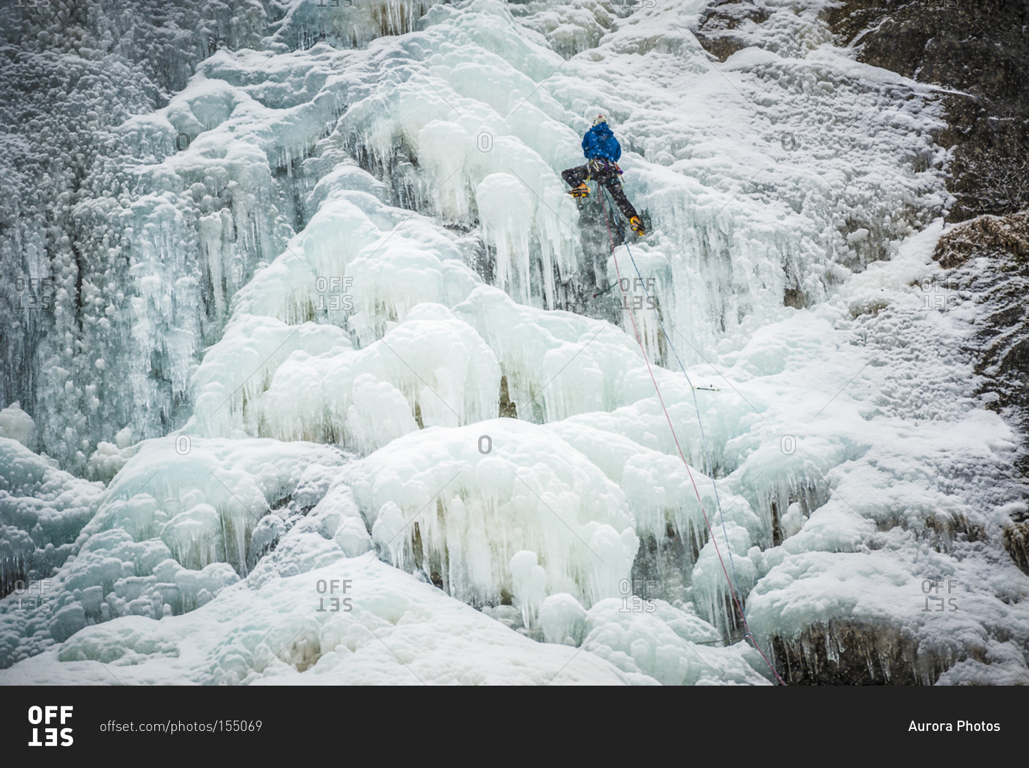 Man lead climbing an ice fall in the middle of a snow storm in Chamonix, France - Stock Image ...