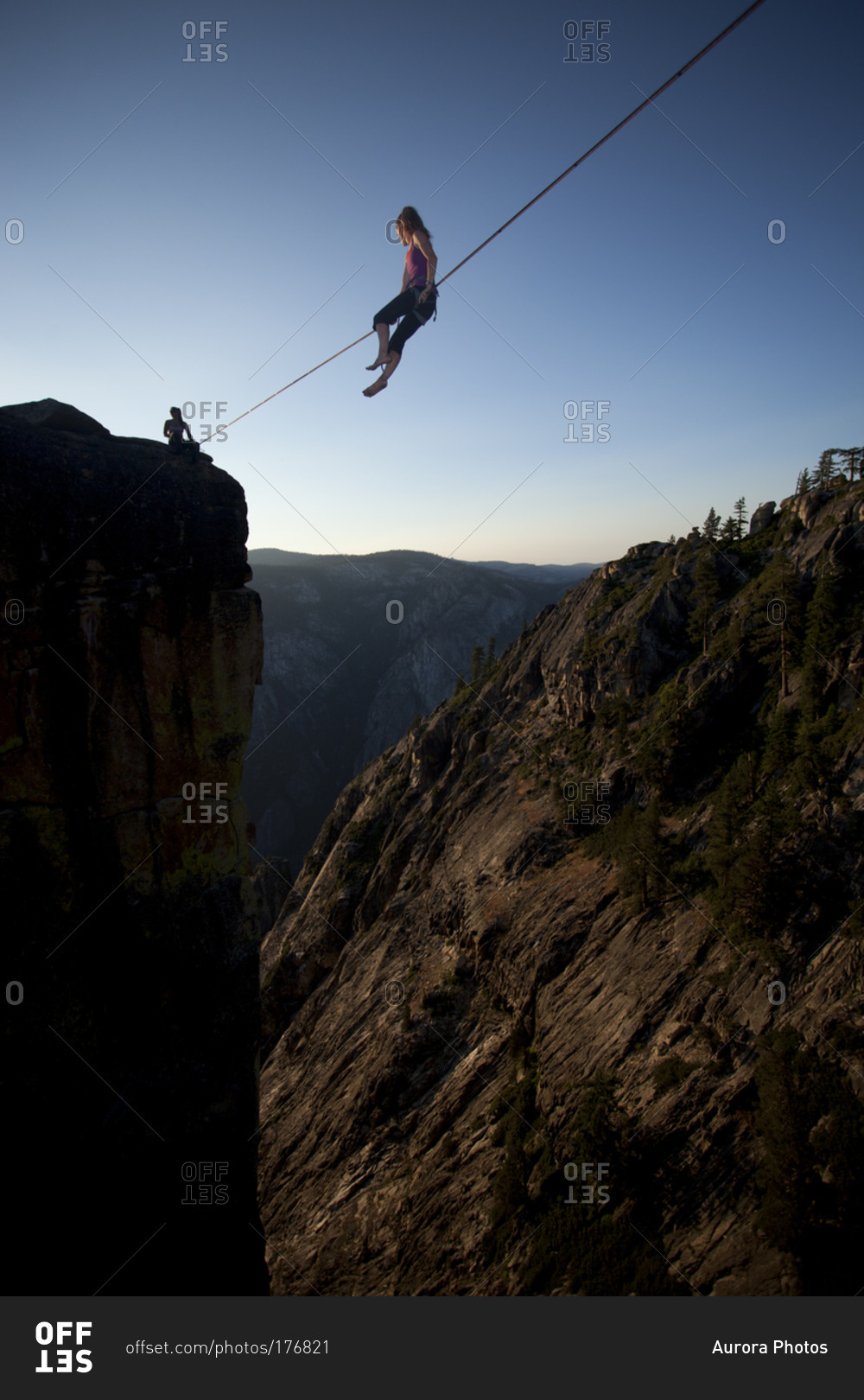 Female highliners sitting on the highline and anchor above the Yosemite ...