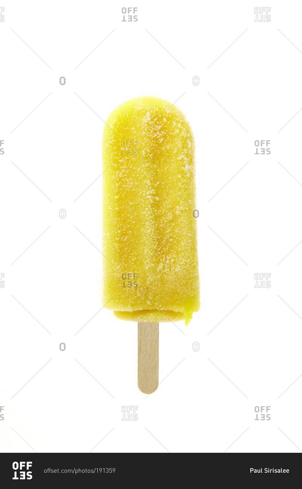 Yellow popsicle on white background stock photo - OFFSET