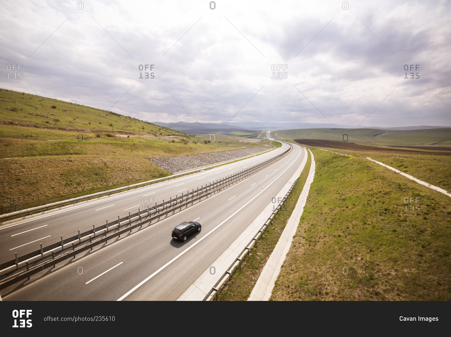 Single car on a highway stock photo - OFFSET