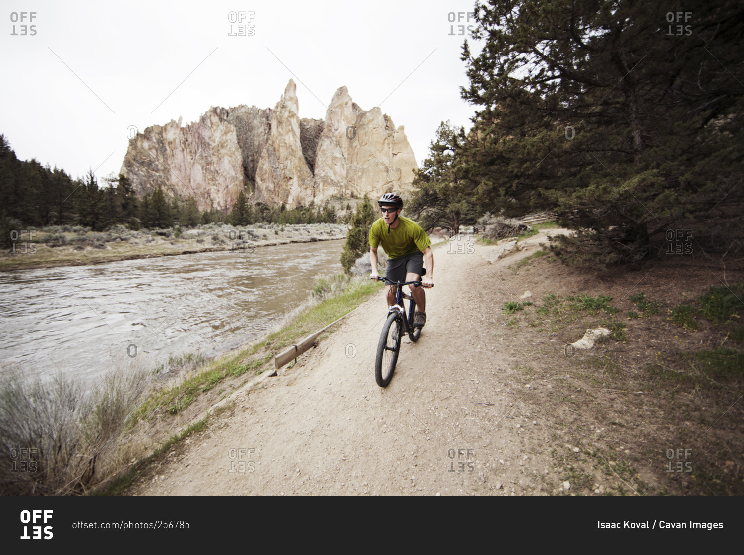 Man riding bike on path in wilderness - Stock Image - Everypixel