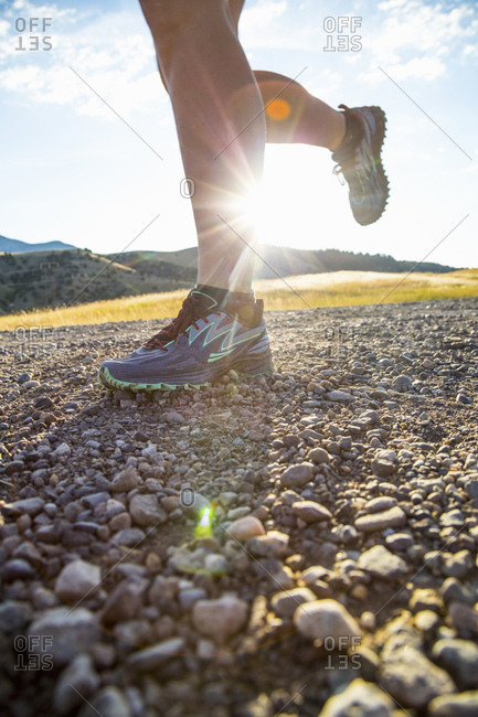 Feet of a runner on a gravel path - Stock Image - Everypixel