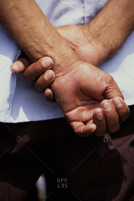 Hands Grabbing Arms Behind Back