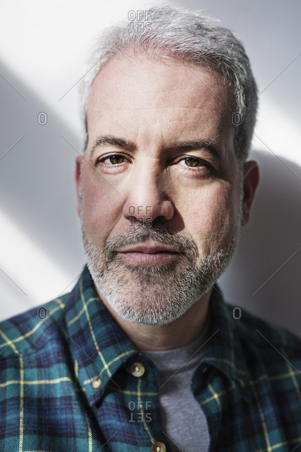 Portrait of a middle-aged man with graying beard stock photo - OFFSET