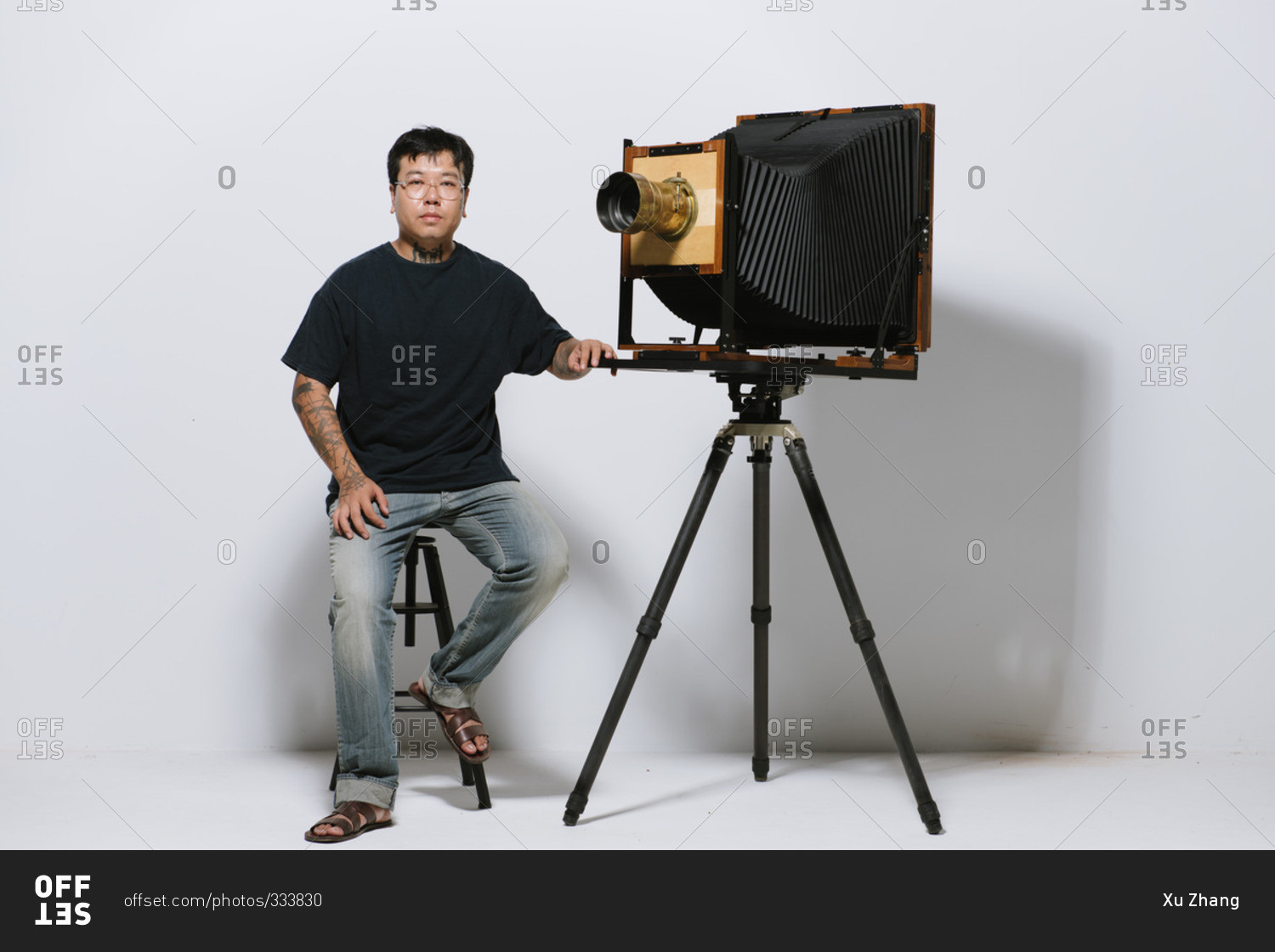 Man with large antique camera stock photo - OFFSET