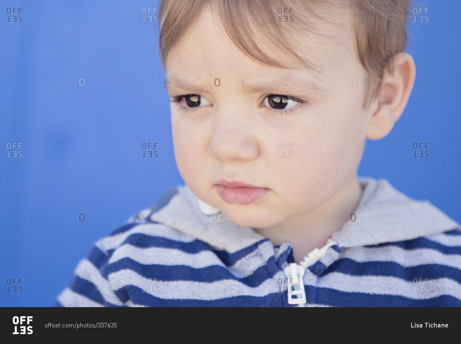 Portrait of a little boy pouting stock photo - OFFSET
