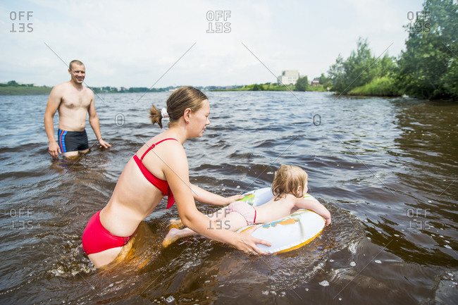 caucasian-family-swimming-in-lake-stock-photo-offset