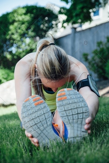 Woman bending forward stretching touching toes - Stock Image - Everypixel