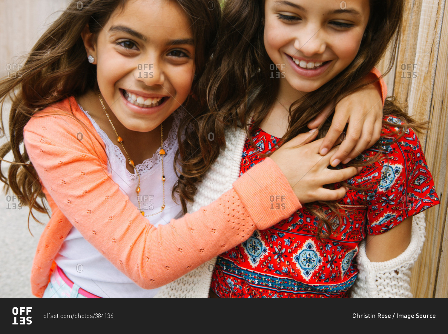 Two girls with arms around each other - Stock Image - Everypixel