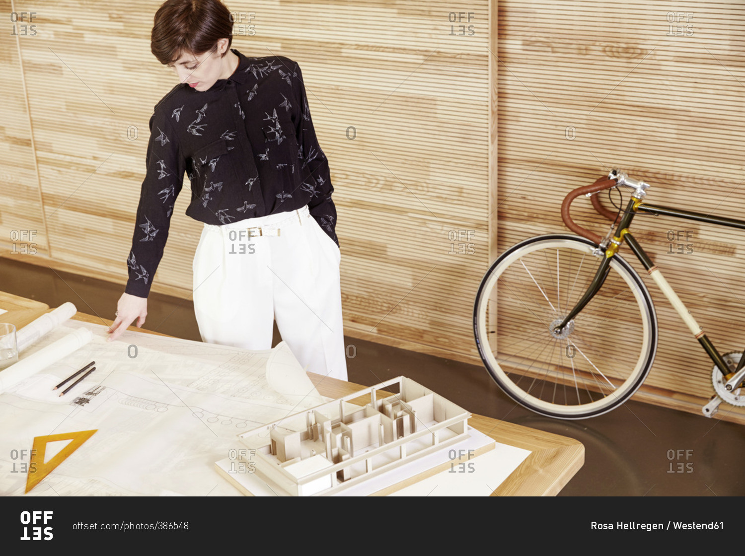 Architect in an office checking drawings - Stock Image - Everypixel