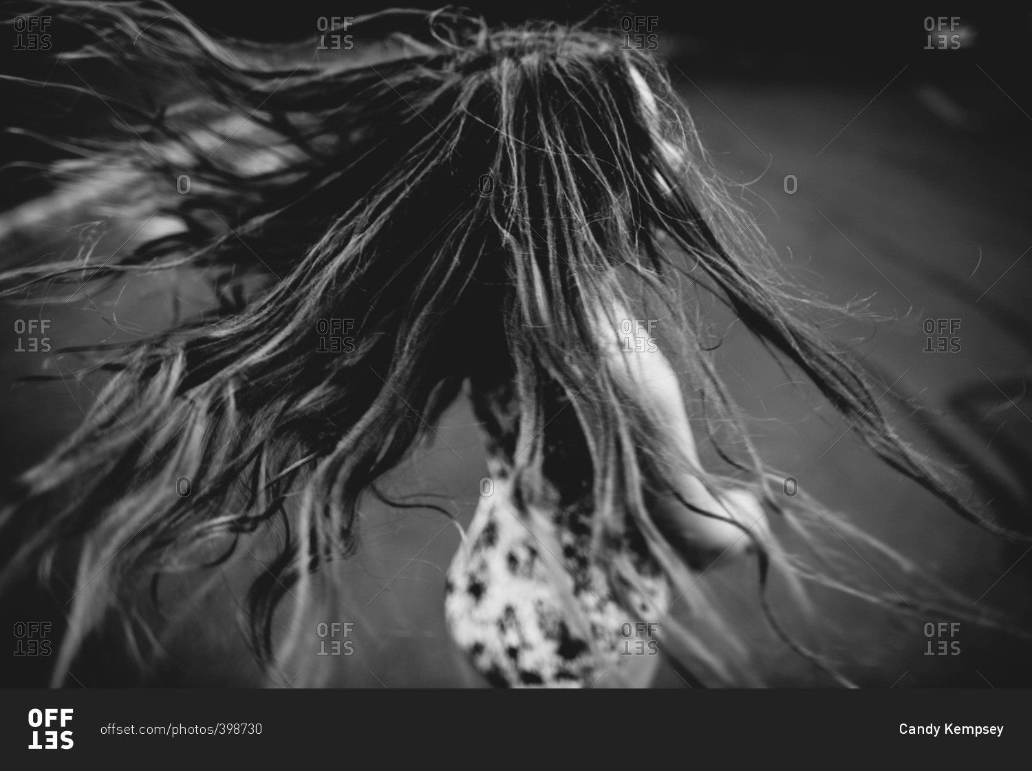 Little girl with long hair spinning around stock photo - OFFSET