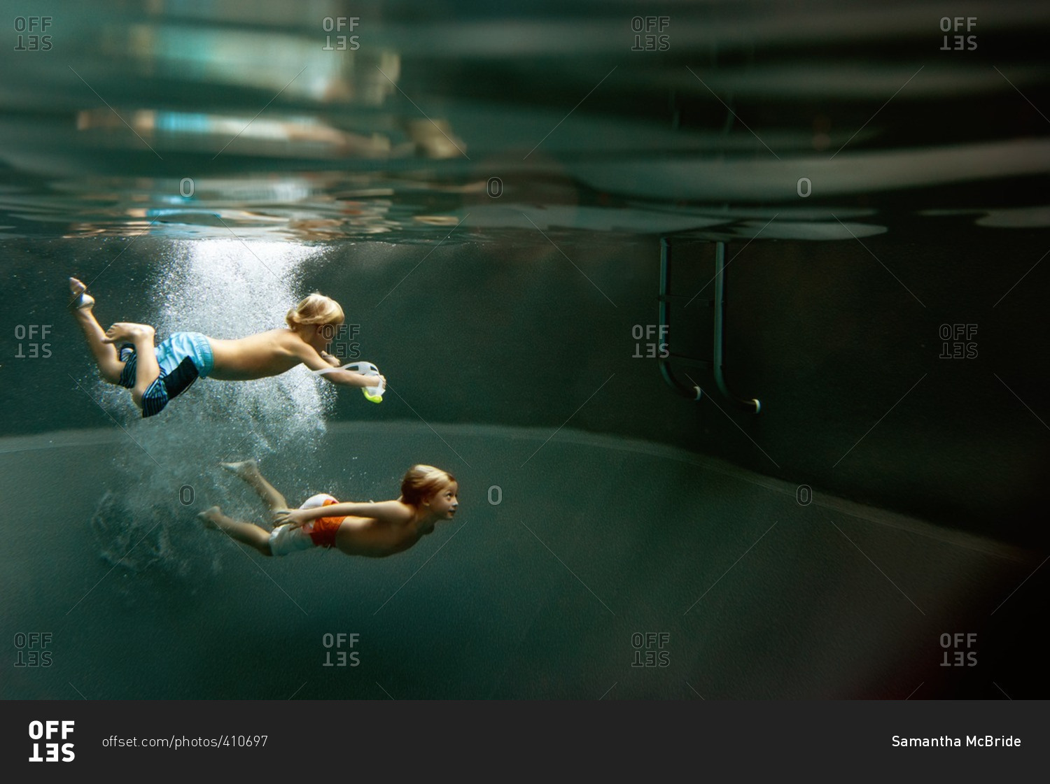 Two boys swimming underwater in the deep end of the pool stock photo ...
