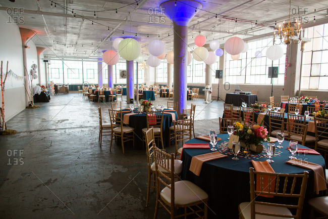 Colorful decorations at a warehouse wedding reception stock photo - OFFSET