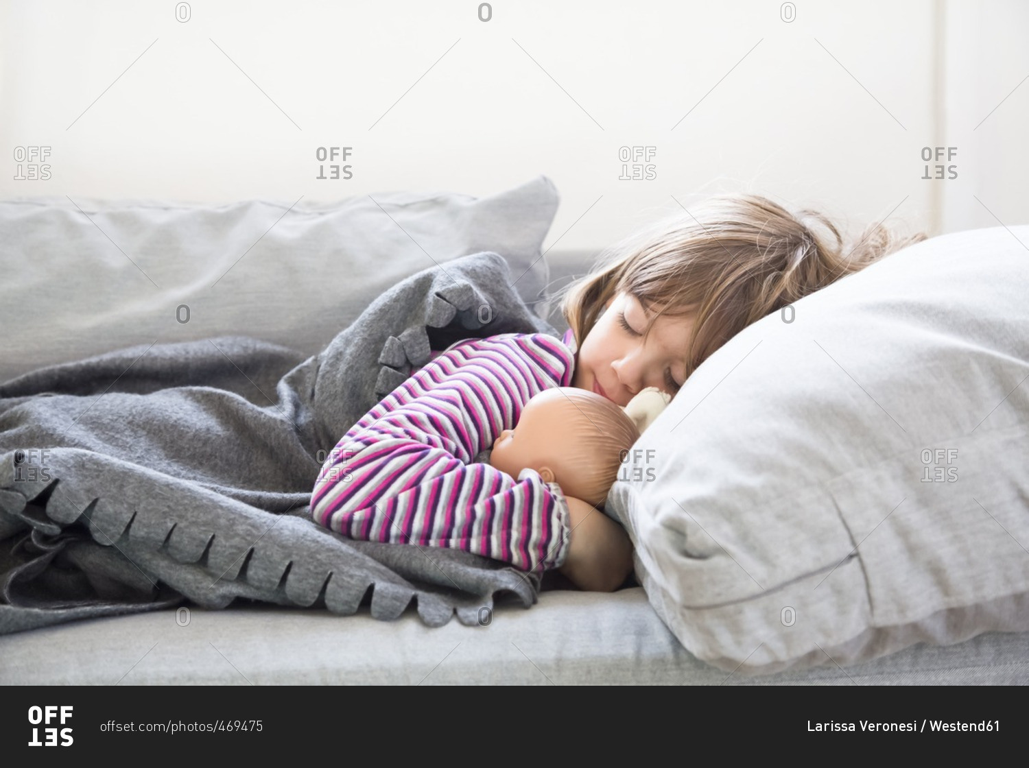 Little girl sleeping on couch stock photo - OFFSET