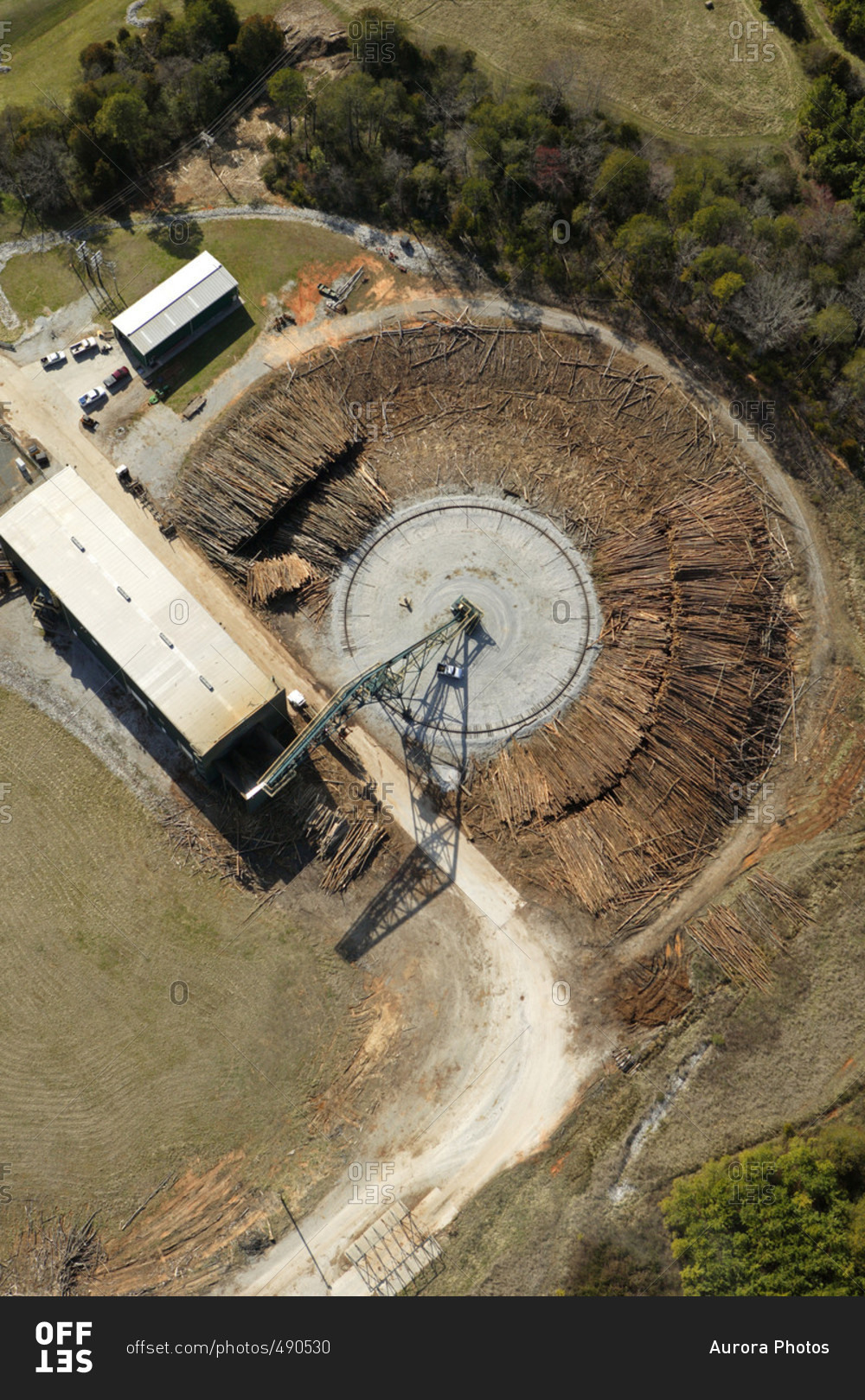 An aerial view of a chip mill and its huge pile of logs ready to be ...