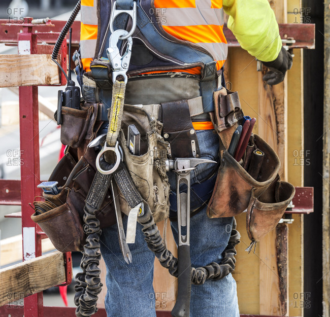 Hispanic Worker Wearing Tool Belt At Construction Site Stock Photo OFFSET Hispanic Worker Wearing Tool Belt At Construction Site Stock Photo OFFSET