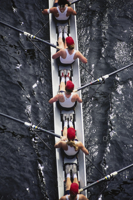 Overhead view of female crew racers rowing a sports racing shell. boat ...