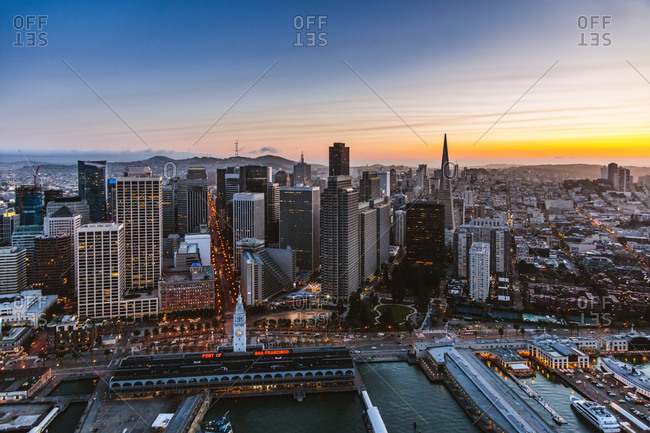 High angle view of skyscrapers by sea against sky at dusk - Stock Image ...