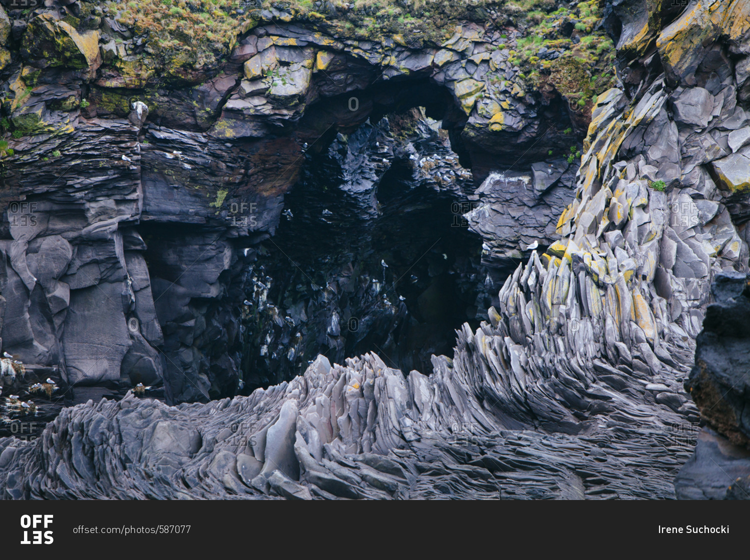 Jagged basalt rock and cave opening in Iceland stock photo - OFFSET