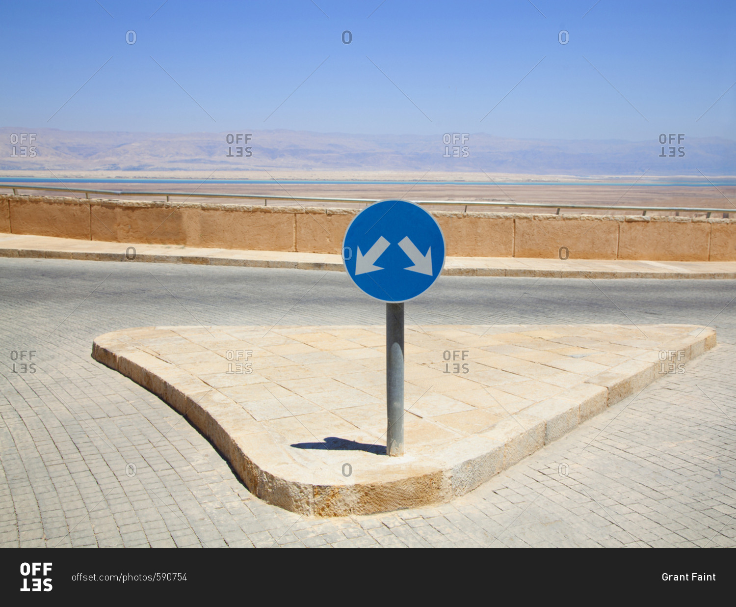 A road sign with two arrows stock photo - OFFSET