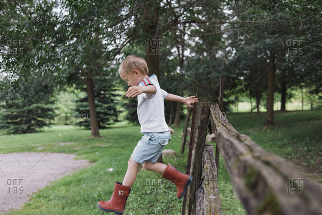 Boy Jumping Over The Fence