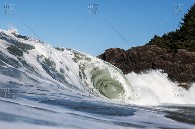 Waves rolling near a shore stock photo - OFFSET