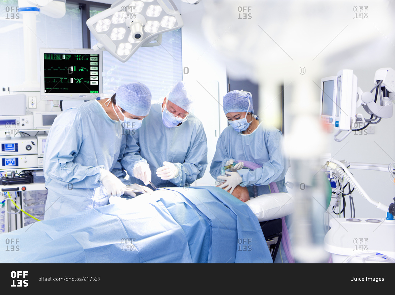 Concentrating surgeons performing operation in operating room stock ...