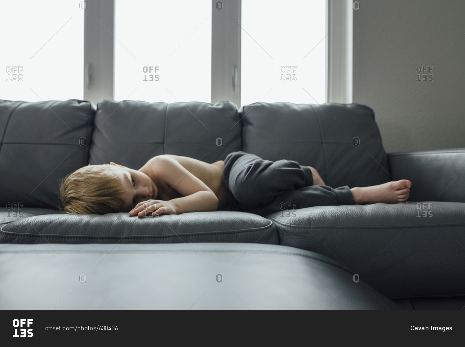 Full length of shirtless boy lying on sofa at home stock photo - OFFSET Full length of shirtless boy lying on sofa at home stock photo - OFFSET