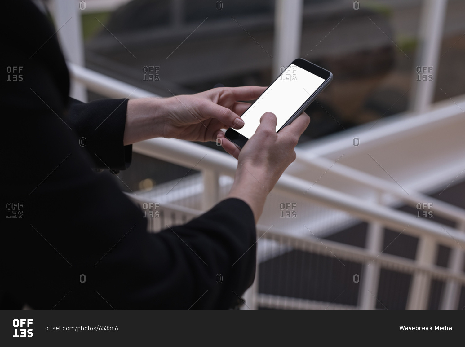 Mid section of female graphic designer using mobile phone in office ...