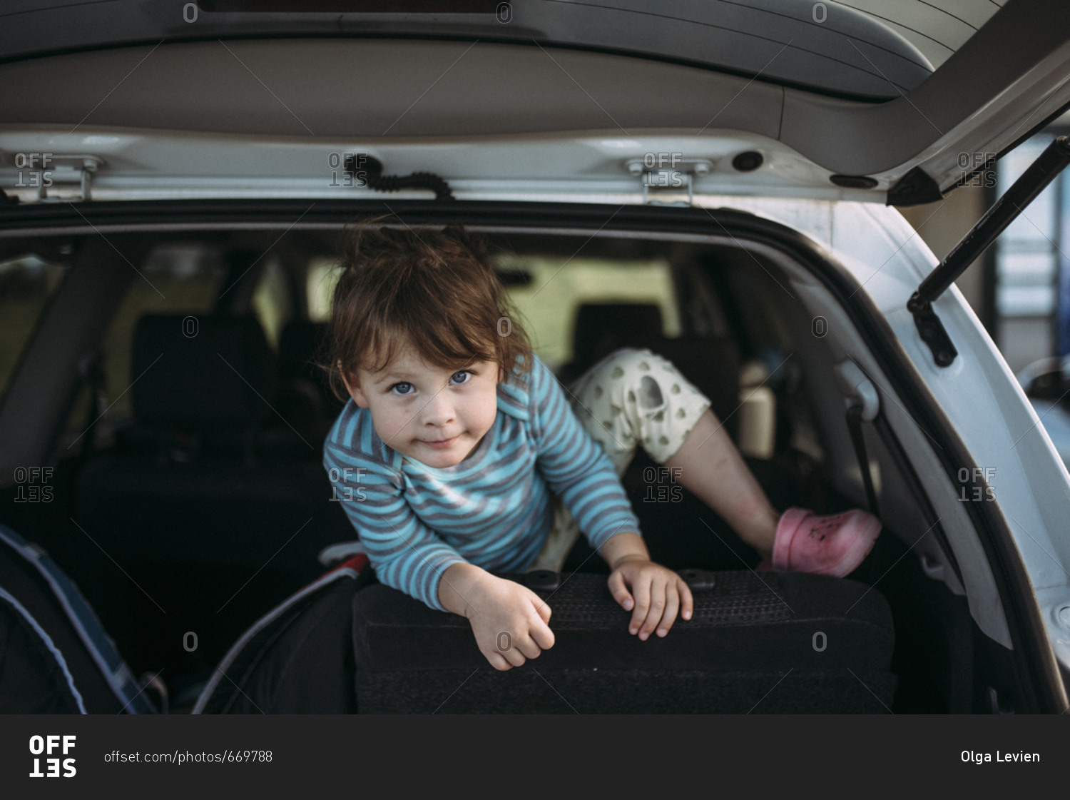 Girl climbing in car - Offset stock photo - OFFSET