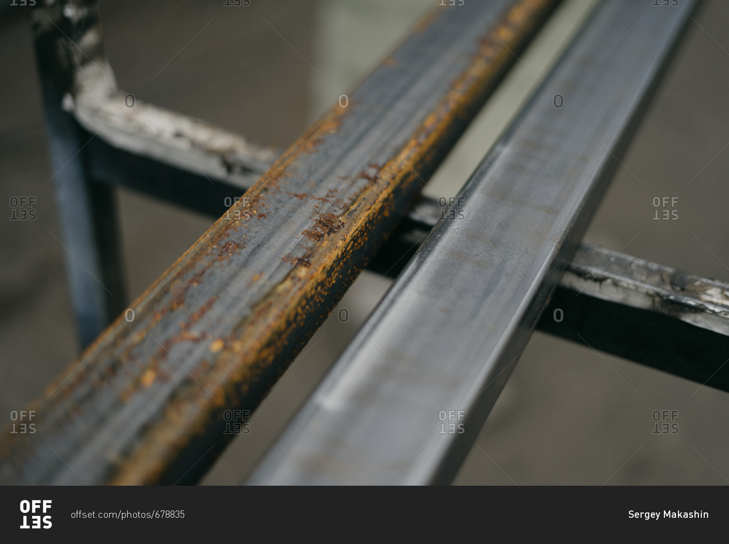 Close up comparison of rusty and non-rusty metal bars stock photo - OFFSET
