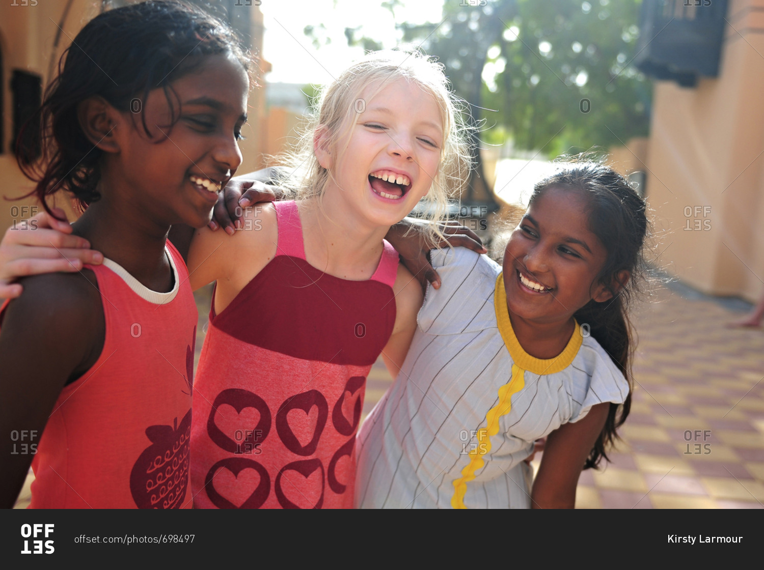 Three Young Girls Of Different Ethnicities Hugging Each Other And