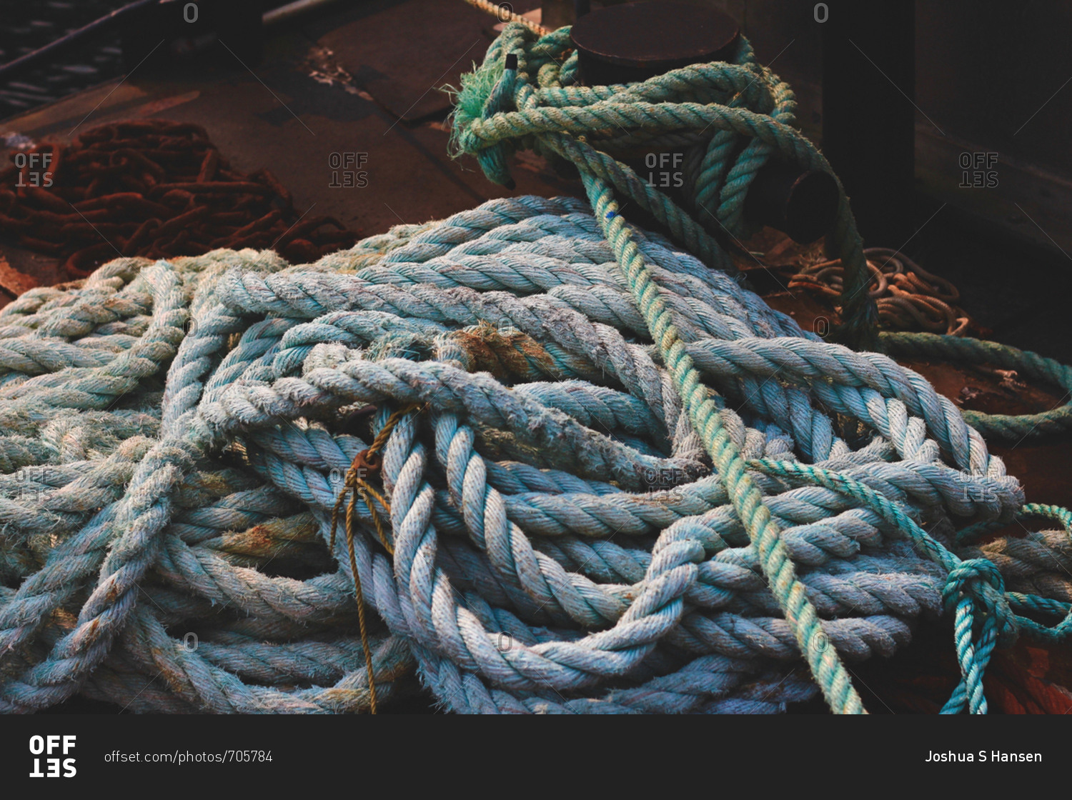 Piles of rope lying on deck of ship stock photo - OFFSET