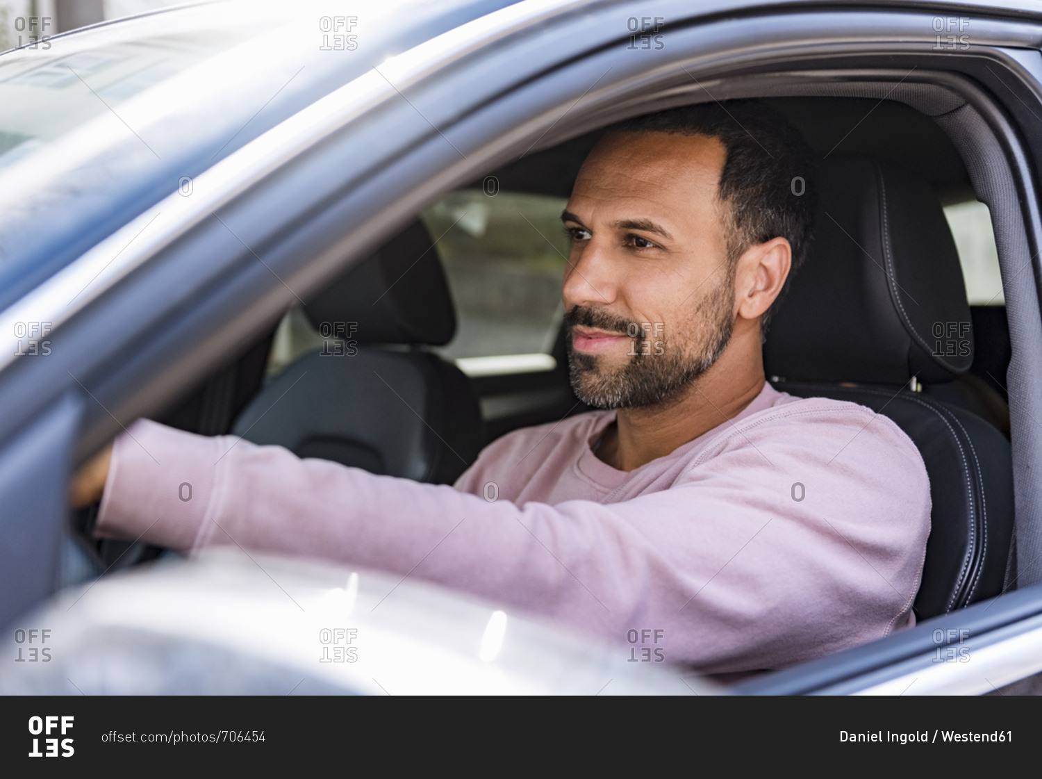 Smiling man driving car - Stock Image - Everypixel