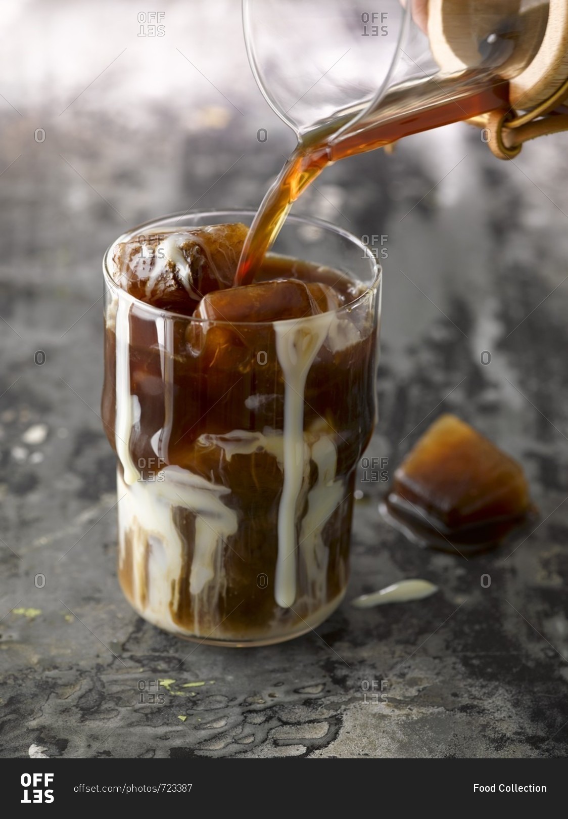 Iced coffee being made: coffee being poured over coffee ice cubes ...