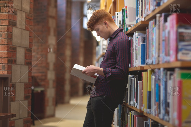 Man Reading Book In Library