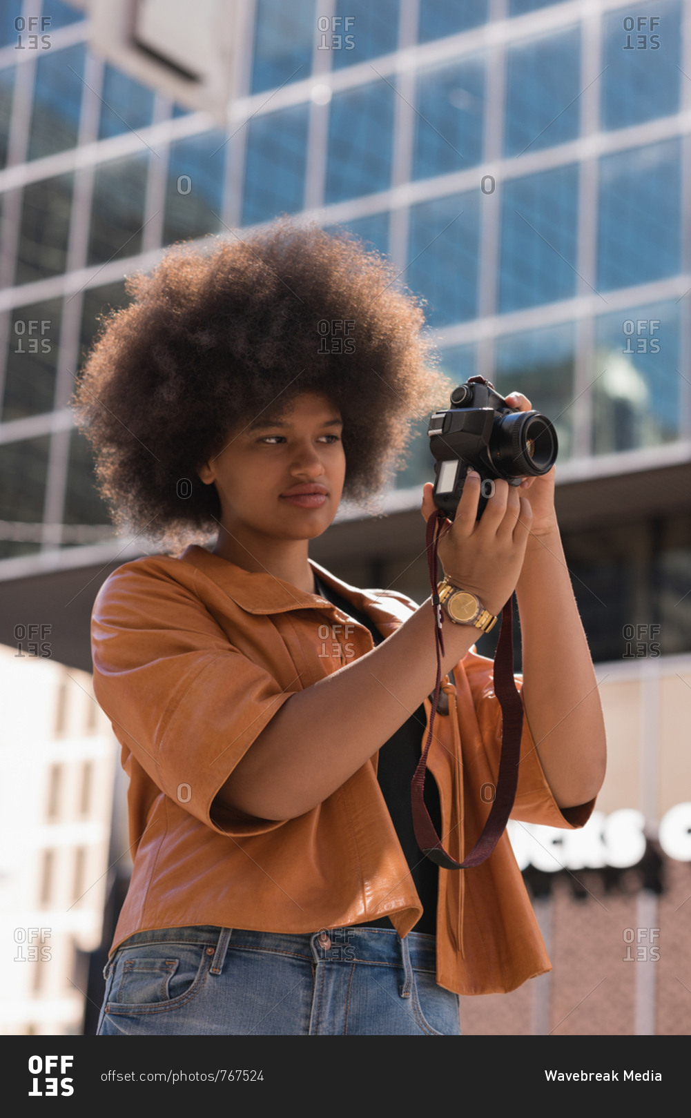 Woman clicking photo with digital camera in city stock photo - OFFSET Woman clicking photo with digital camera in city stock photo - OFFSET