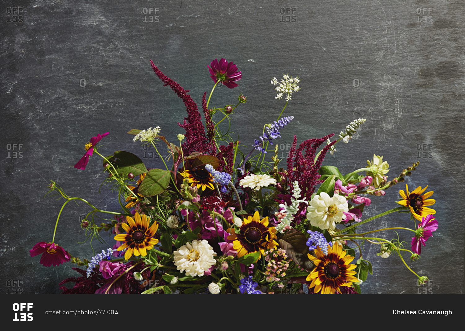 Flower arrangement on slate stock photo - OFFSET