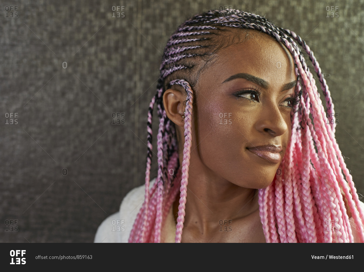 Portrait of young woman with pink braids stock photo - OFFSET