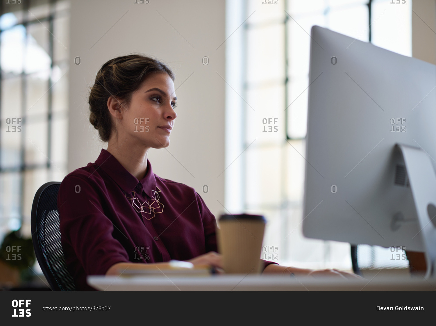 Business woman using computer in office looking at screen stock photo ...