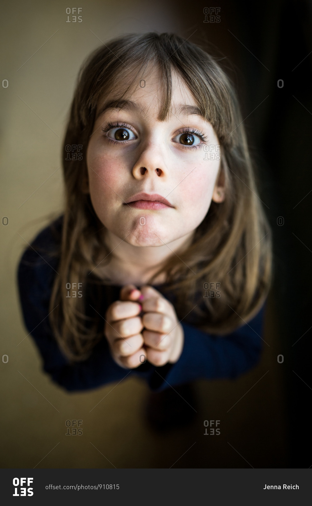 Silly girl making a pleading expression stock photo - OFFSET