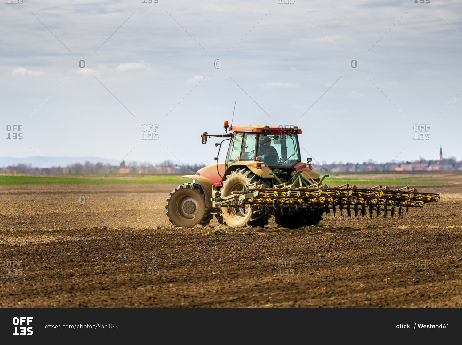 Farmer in tractor plowing field in spring - Stock Image - Everypixel